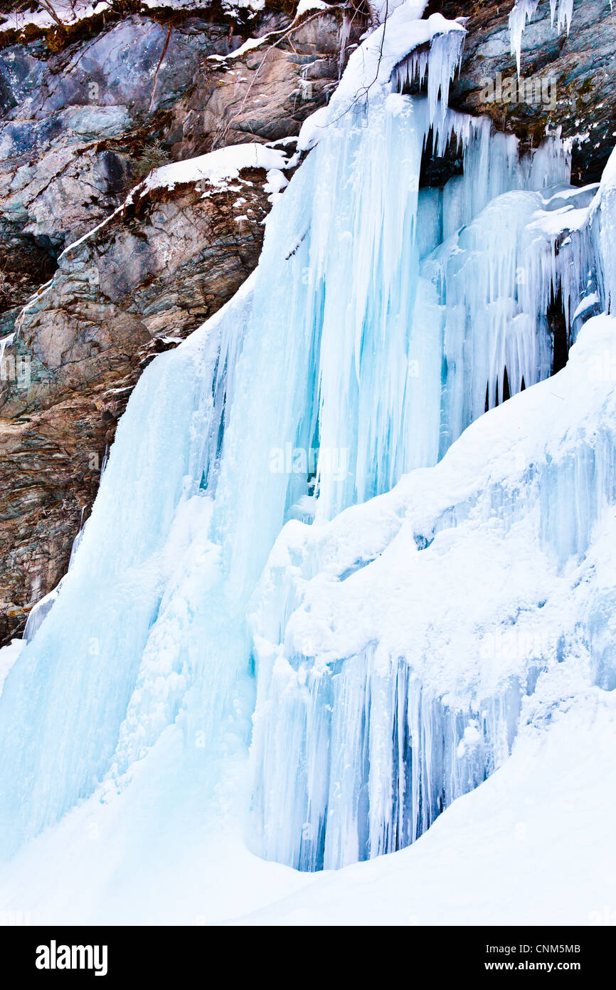Huge icicles formed in a waterfall on a mountain Stock Photo - Alamy