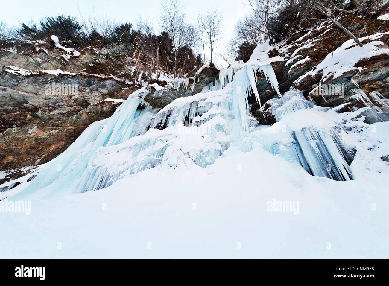 Huge icicles formed in a waterfall on a mountain Stock Photo - Alamy