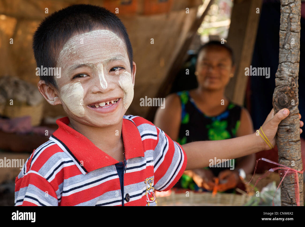 Portrait of a Burmese boy with tanaka face painting. The use of Tanaka ...
