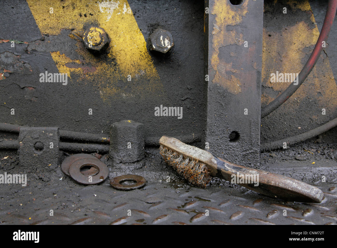 Dirty wire brush and steel washers on oily steel checker plating Stock ...