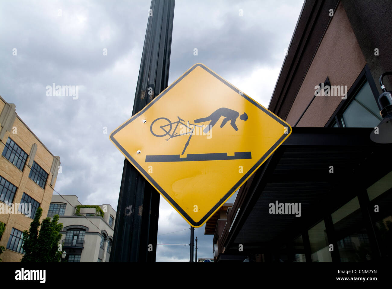 Traffic sign warning bicycle riders of railway tracks on street Stock ...