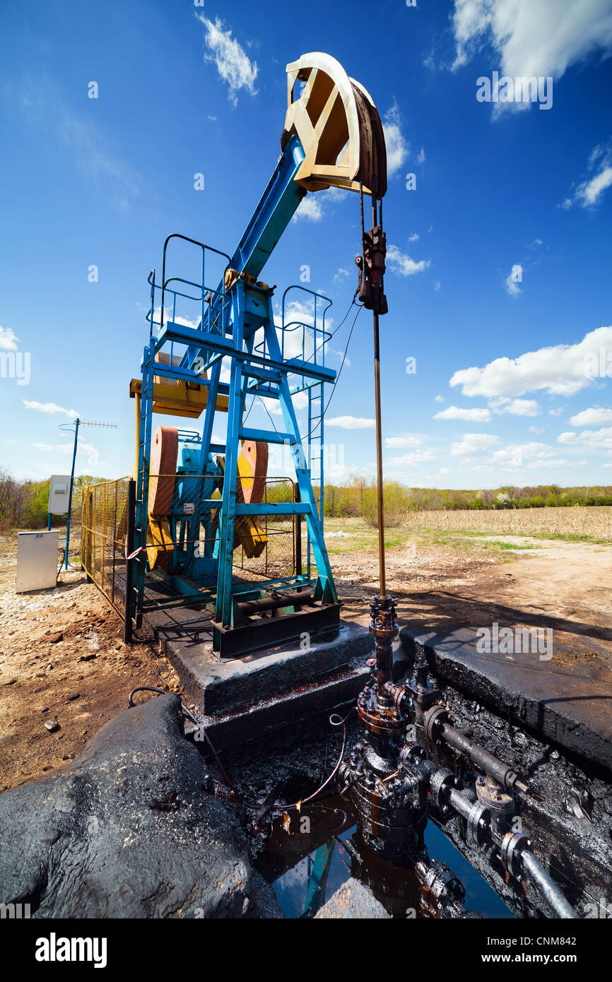 Landscape with oil pump under blue sky with clouds in a sunny day Stock ...