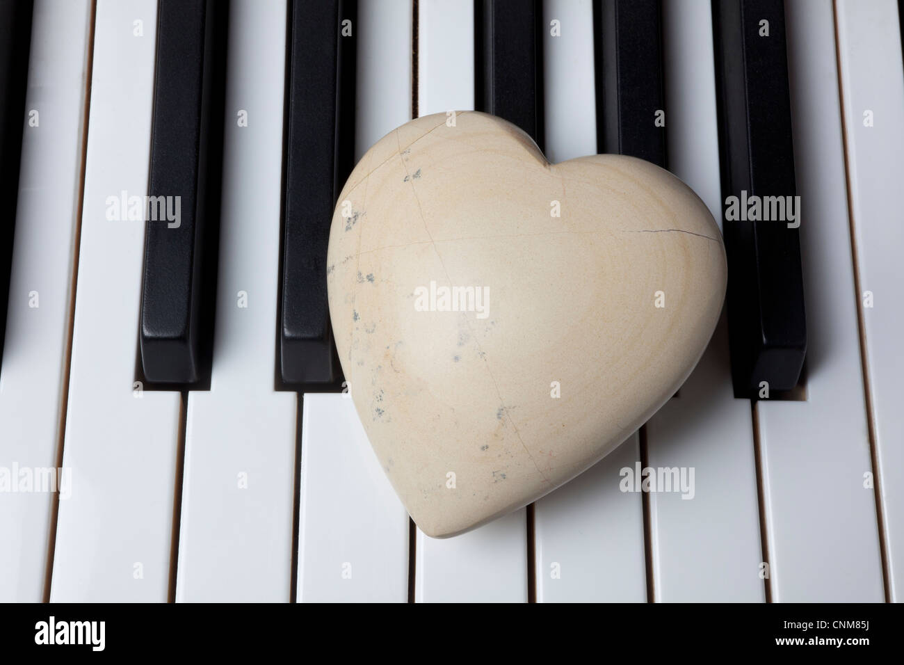 White stone heart on piano keys Stock Photo - Alamy