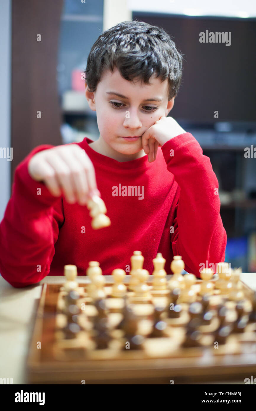 Closeup portrait of a school boy playing chess, selective focus Stock ...