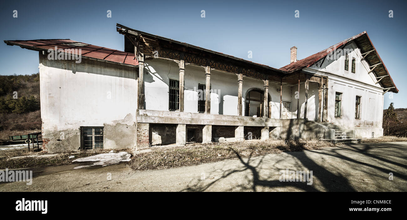 Moody split toned landscape with a decrepit house Stock Photo - Alamy