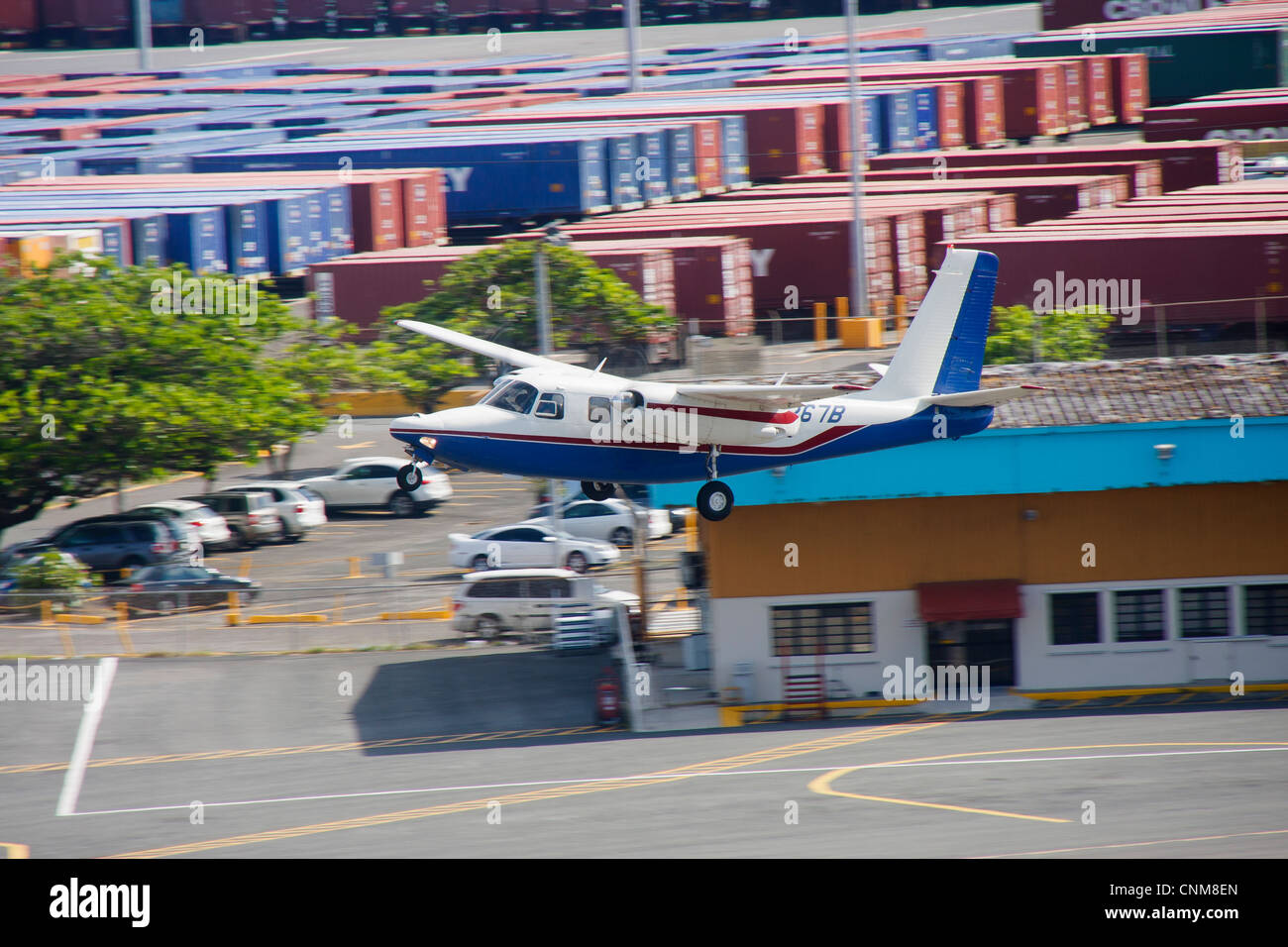 A small aircraft landing at a freight terminal Stock Photo - Alamy
