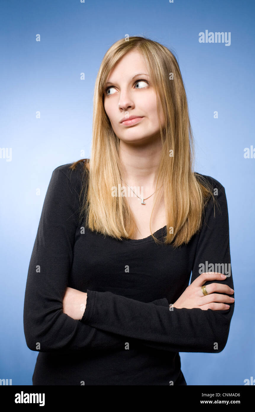 Young blond woman with funny facial expression showing denial, frowning ...