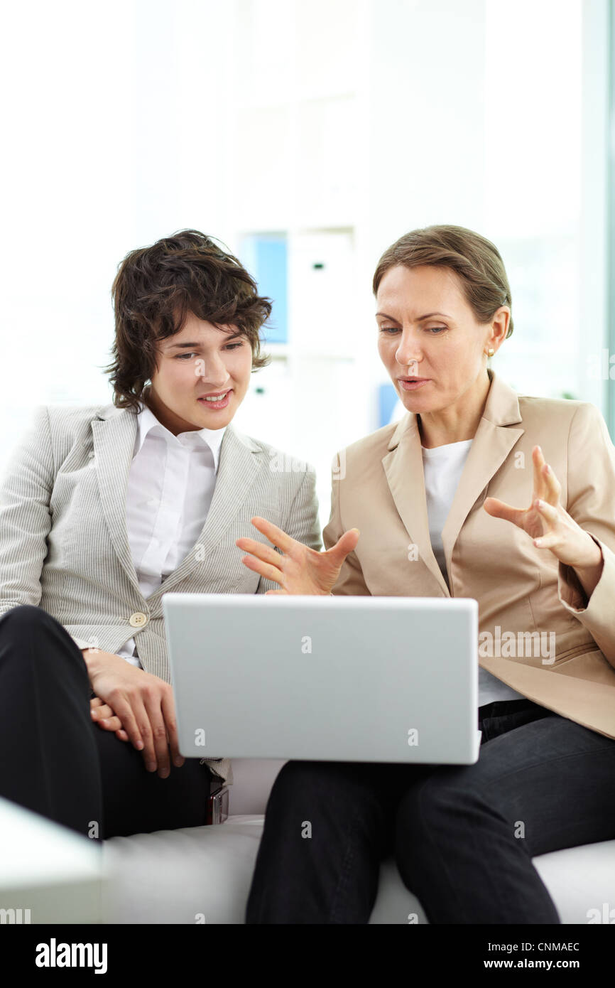 Portrait of two business women interacting in office Stock Photo - Alamy