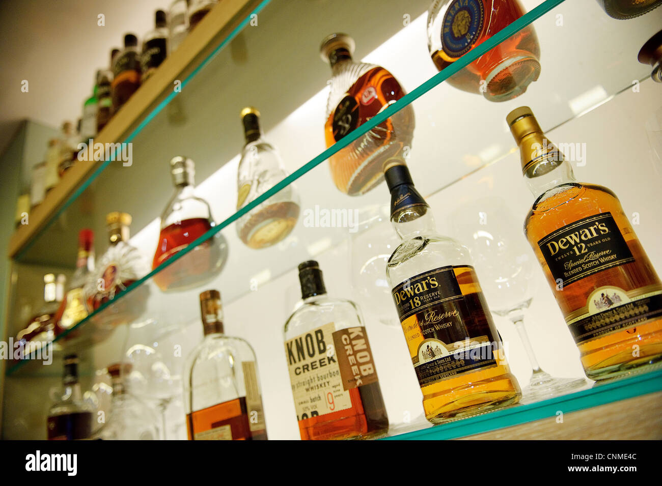 glass shelves with bottles of spirits alcohol Stock Photo - Alamy