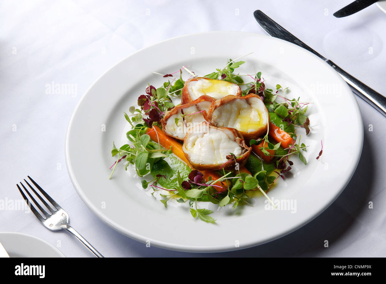 white plate on restaurant table of fish salad Stock Photo - Alamy
