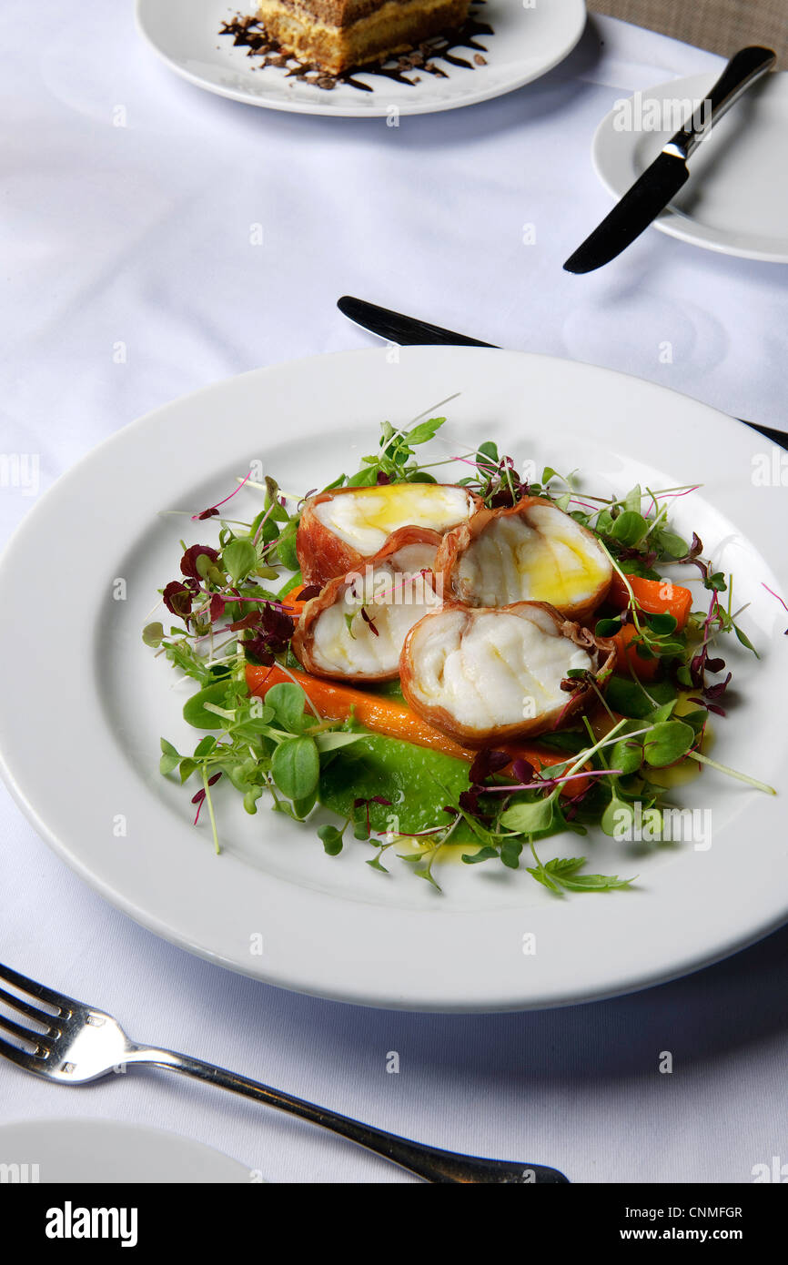 white plate on restaurant table of fish salad Stock Photo - Alamy