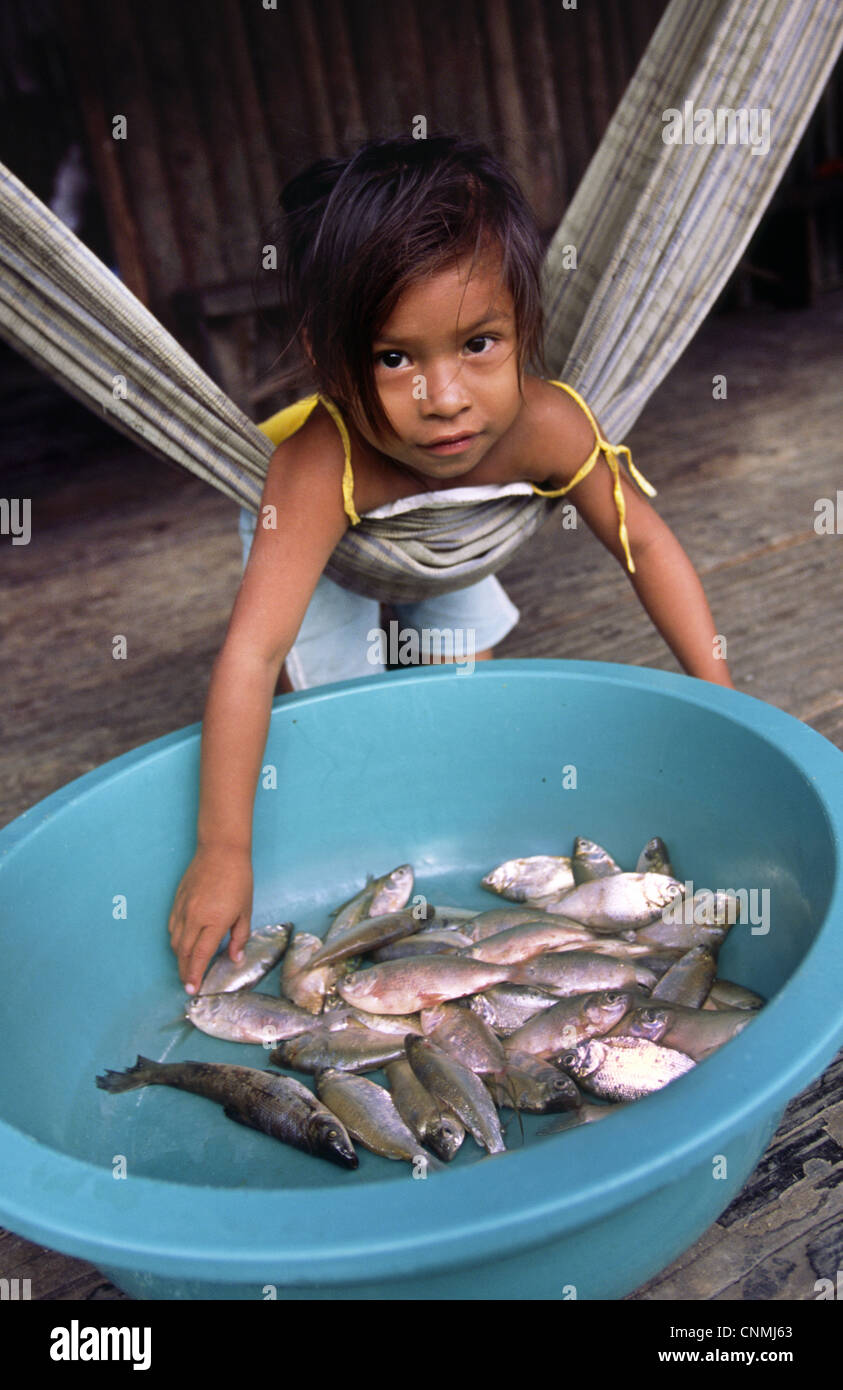 Girl with freshly caught fish. Tamishiyaco village on the Amazon River ...