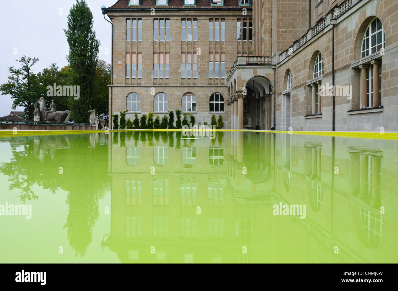 Zurich University building reflecting in a yellow water pool Stock ...