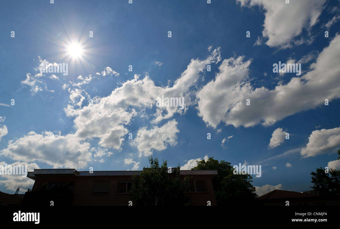 Cloudy blue sky with sun Stock Photo - Alamy
