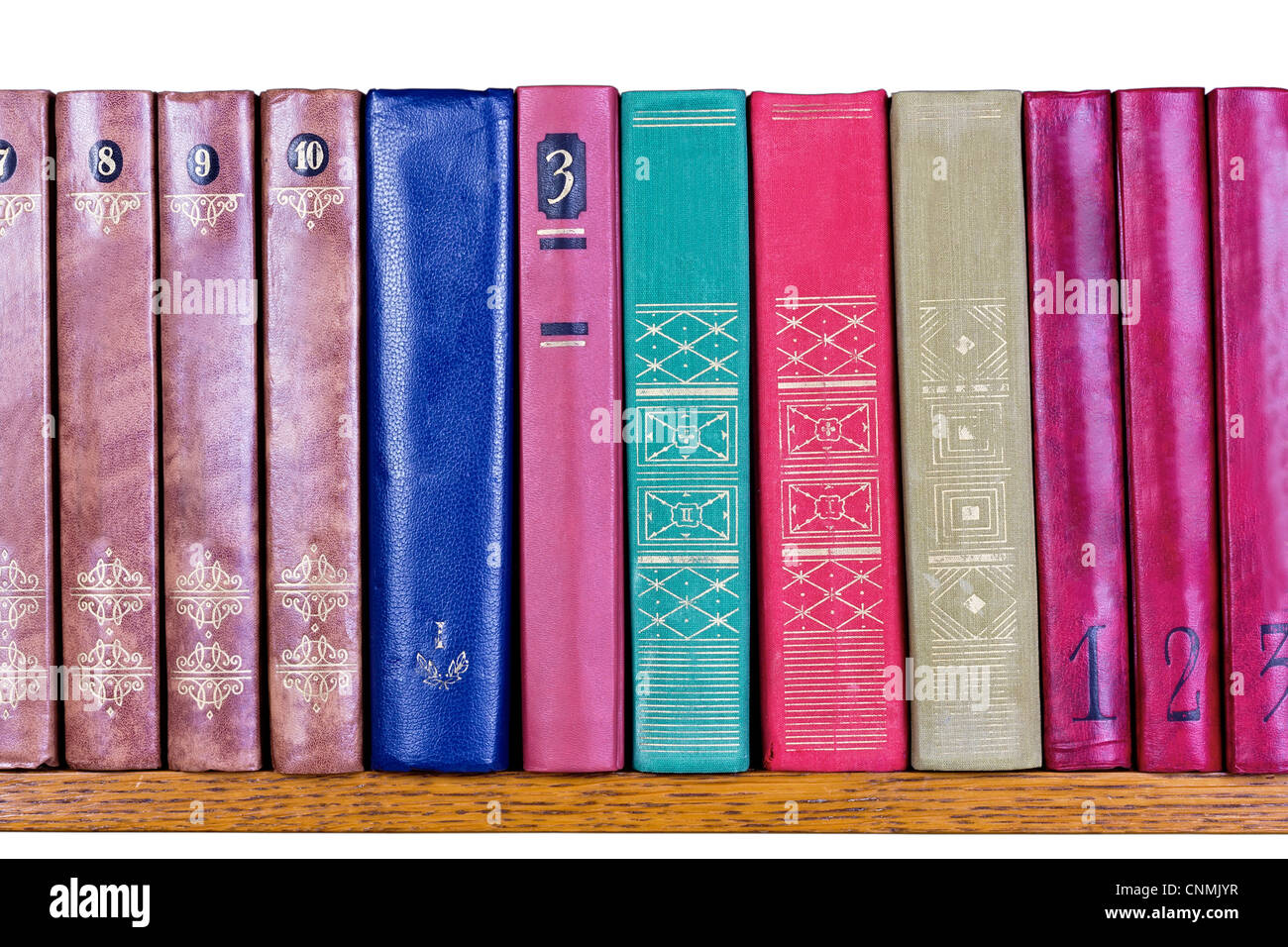 Old retro books with color covers on a wooden shelf front view. Mass ...