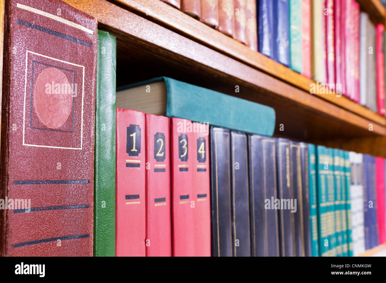 Old retro books with color covers on a shelf perspective background ...