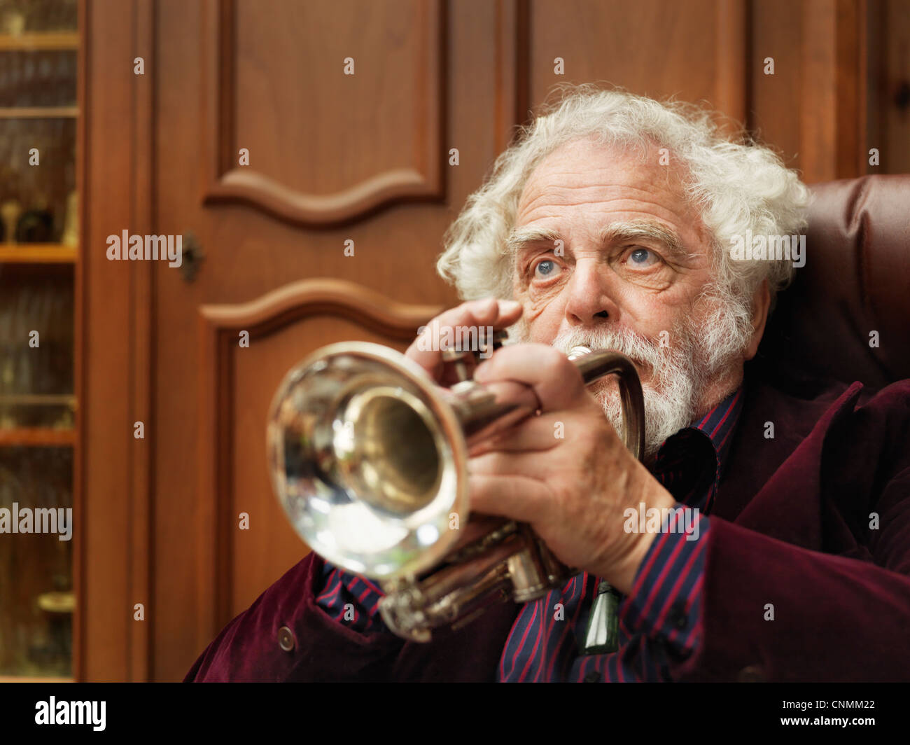 Older man playing trumpet indoors Stock Photo - Alamy