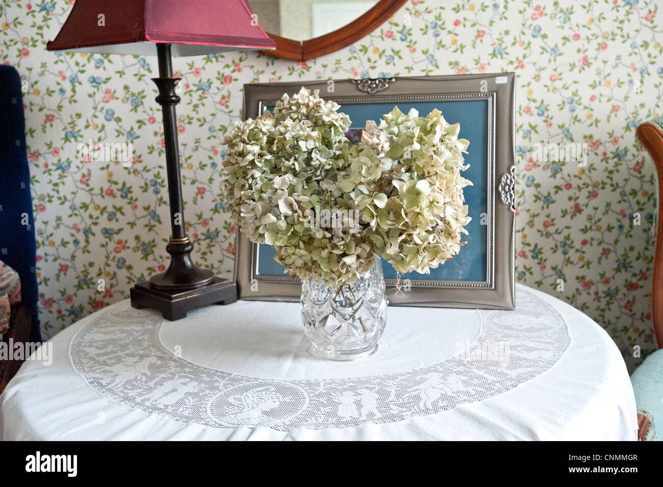 Floral arrangement on a bedside table in a bedroom furnished with ...