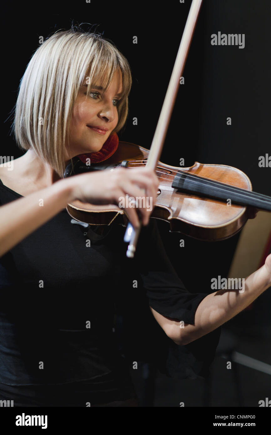 Violin player in orchestra Stock Photo - Alamy