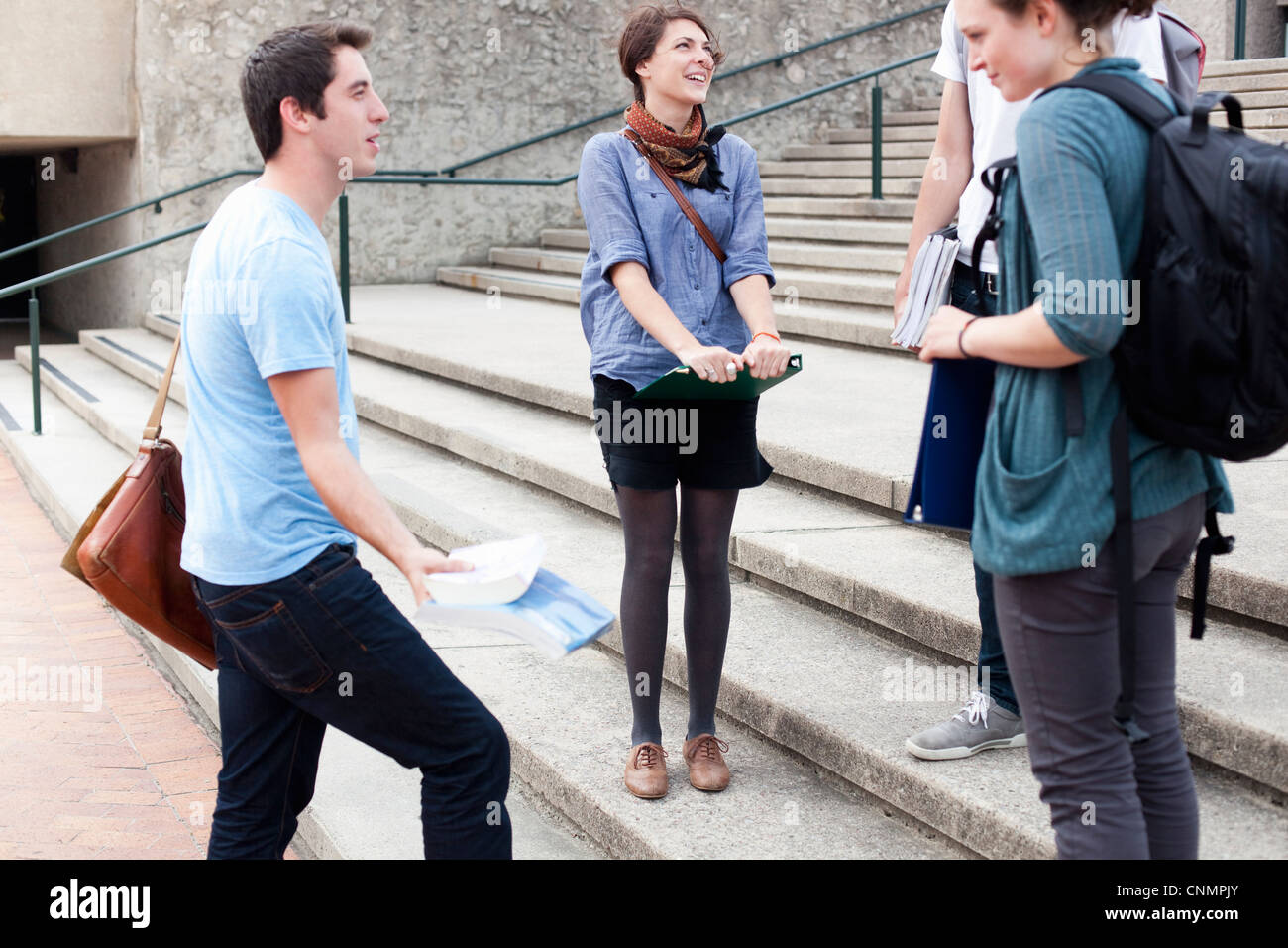 Students talking on campus steps Stock Photo - Alamy