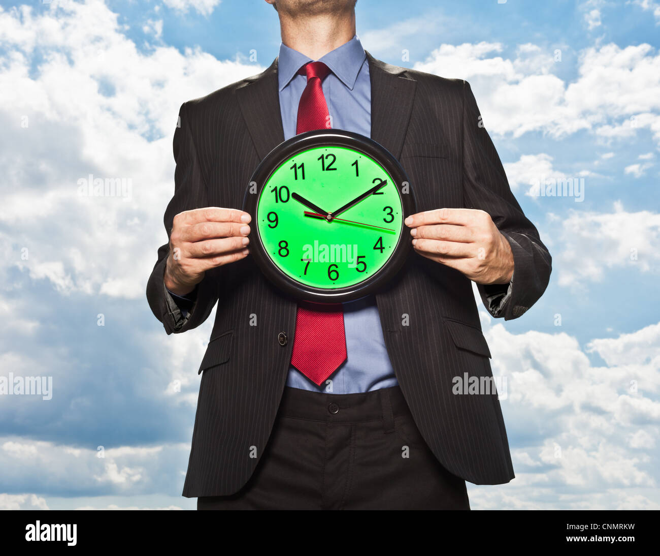 Businessman holding clock Stock Photo - Alamy
