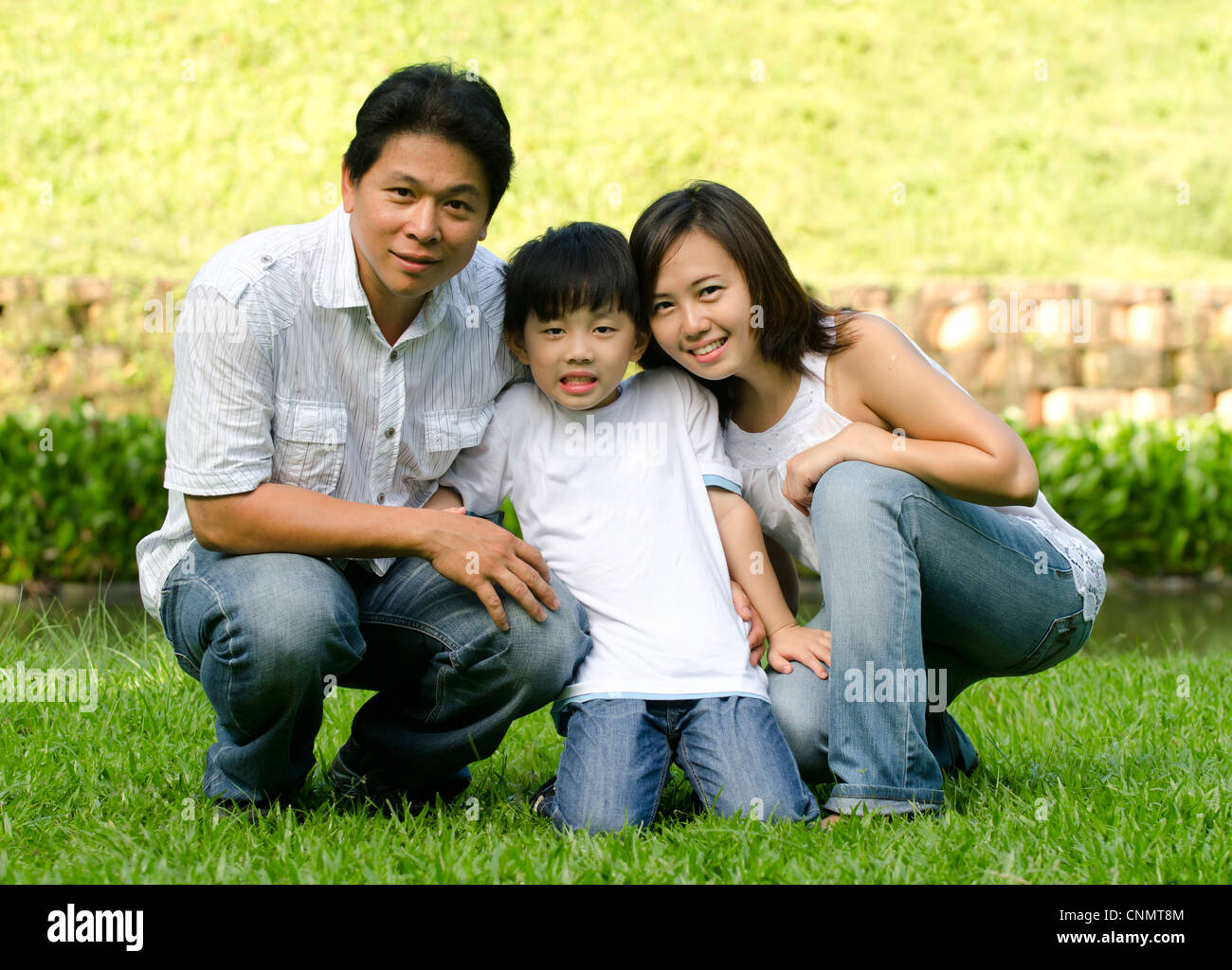 asian family with green background Stock Photo - Alamy