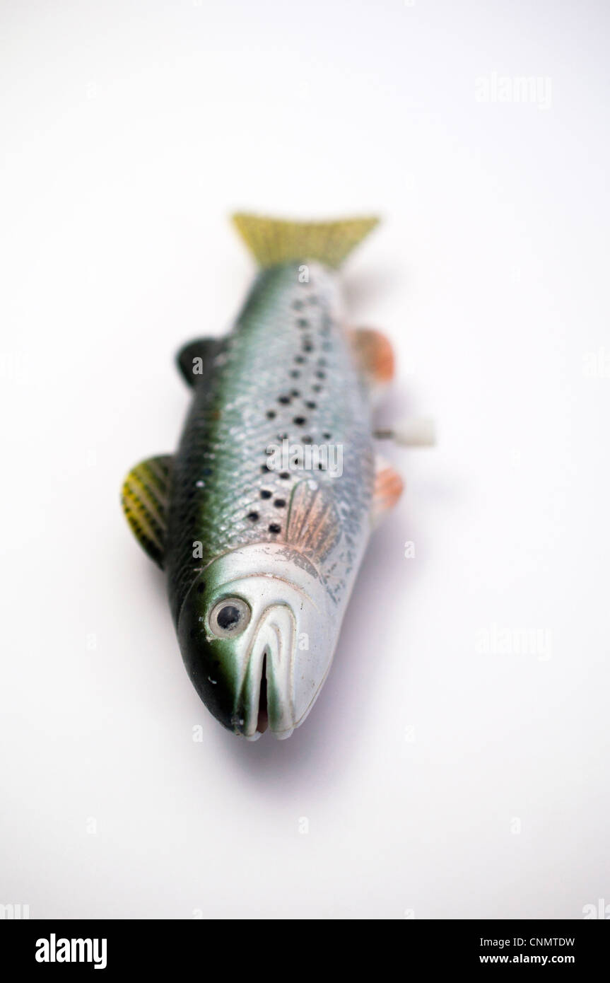 Fish out of water - a toy clockwork fish on a white background Stock ...