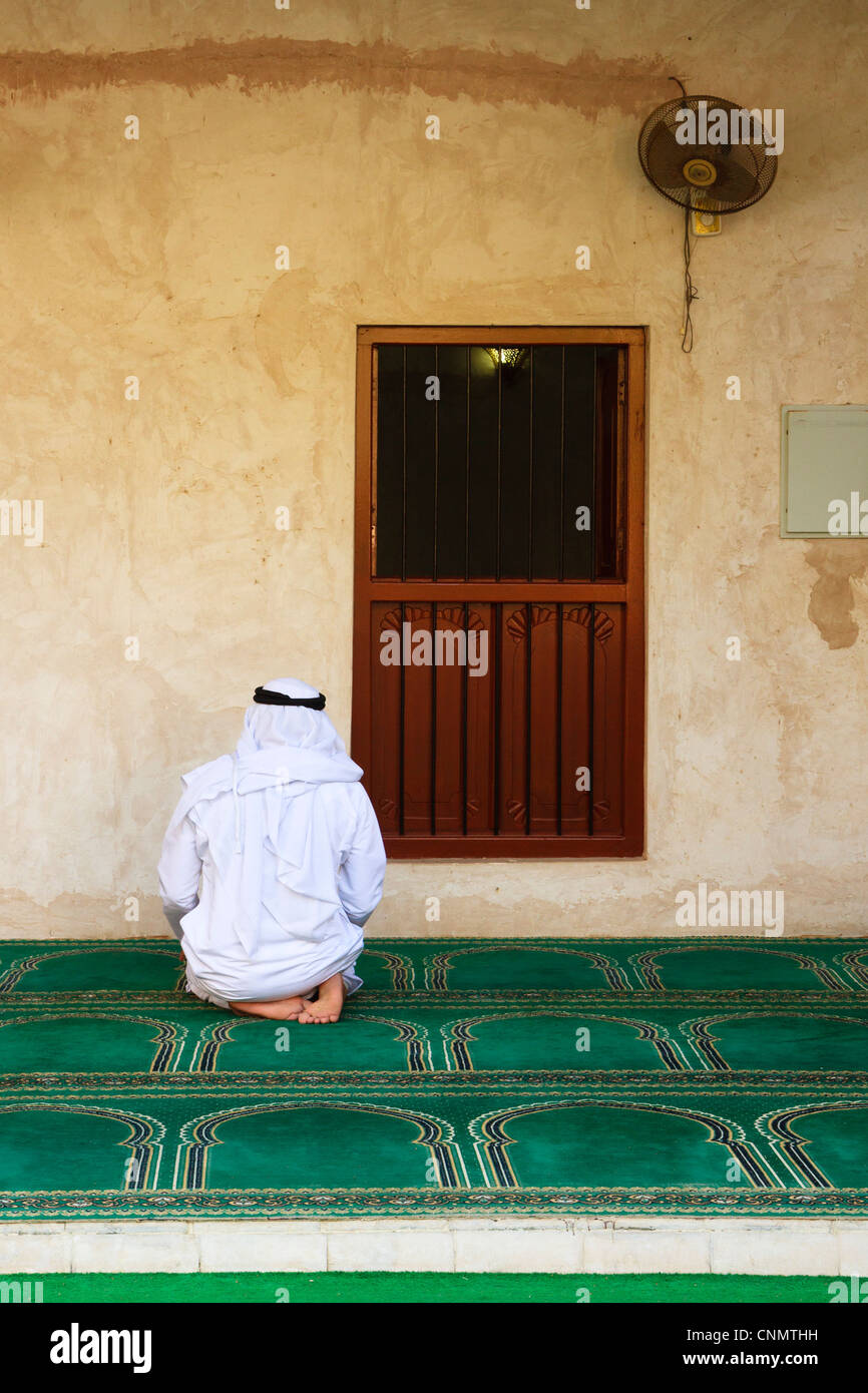 Muslim man praying at the traditional mosque in the Abu Dhabi Heritage ...