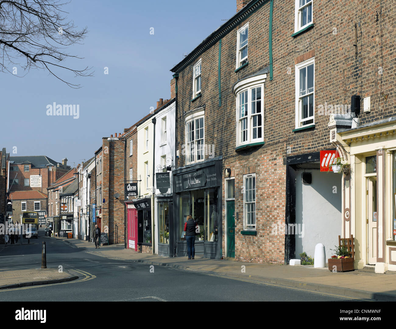 Shops stores along Walmgate in spring York North Yorkshire England UK ...