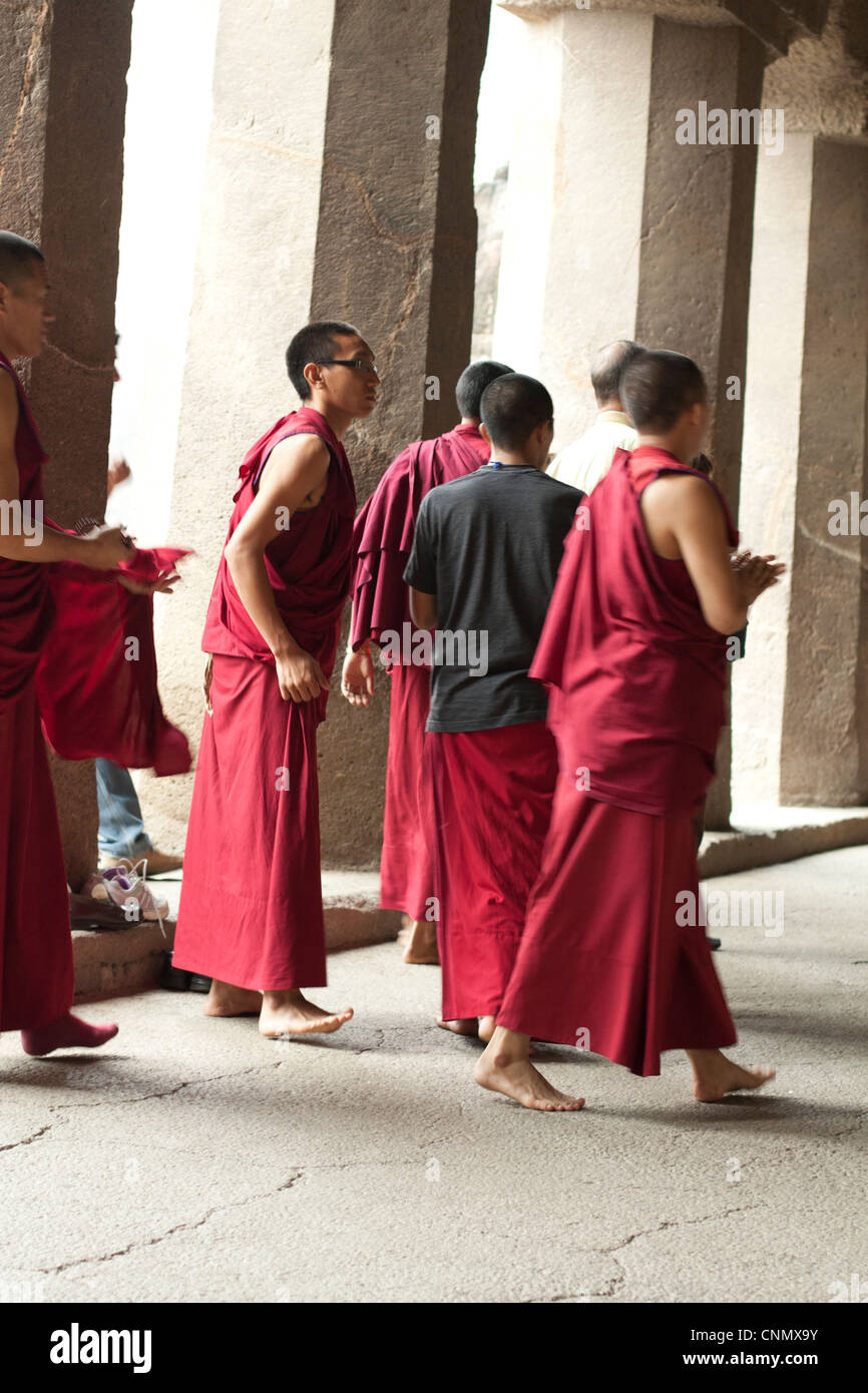 Red robed priests walking through Pillars at Shrine, India Stock Photo ...