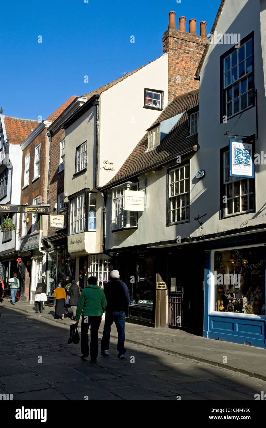People tourists visitors walking by stores shops pedestrianised street ...
