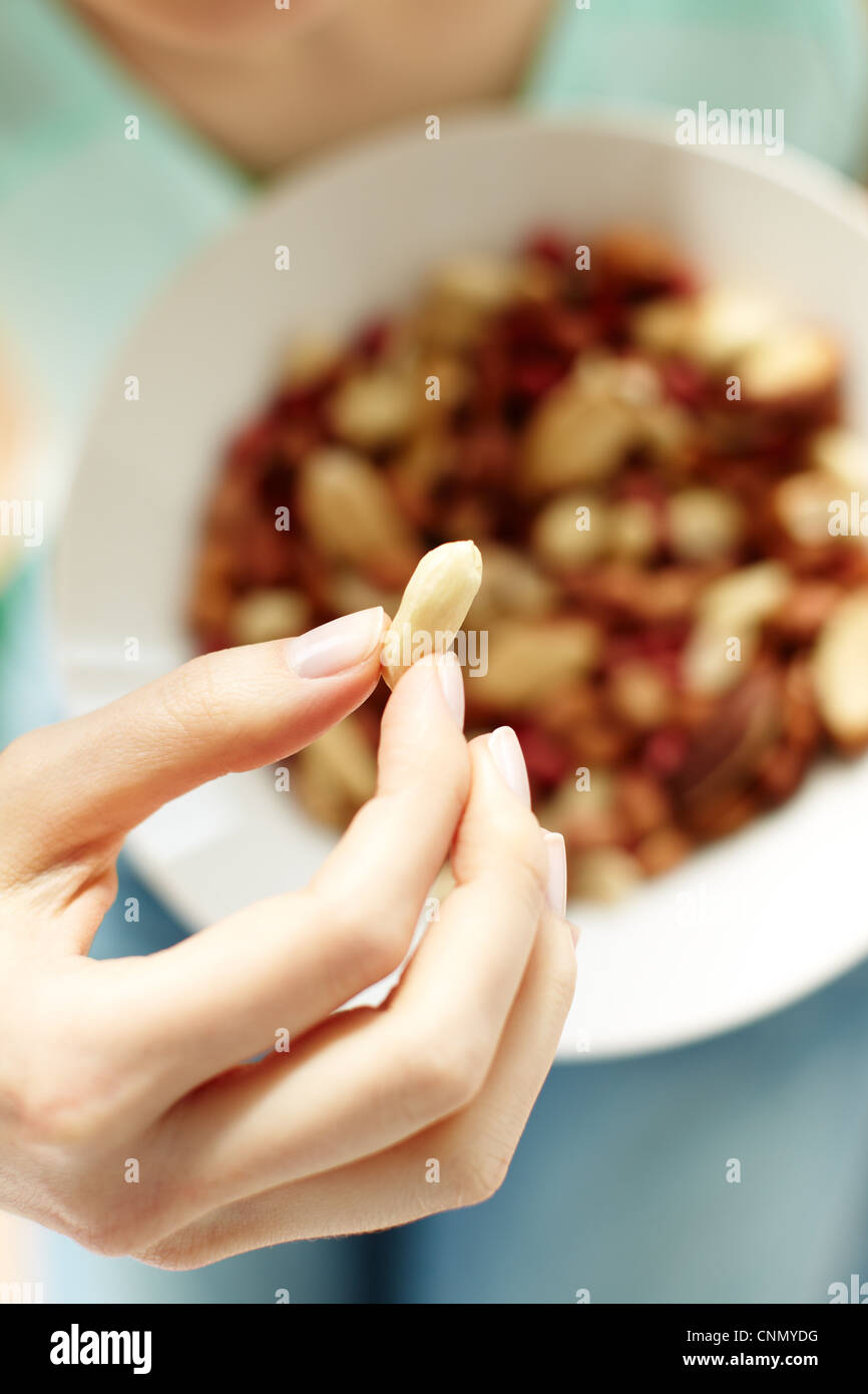 Girl eating nuts Stock Photo - Alamy