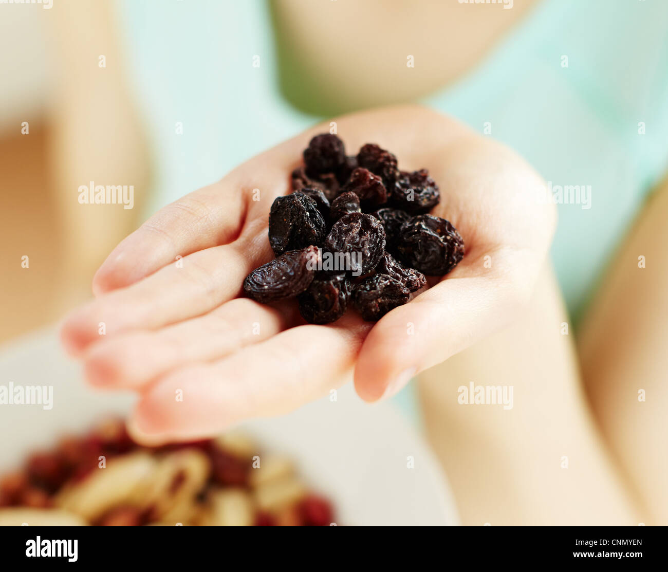 Girl holding raisins Stock Photo - Alamy
