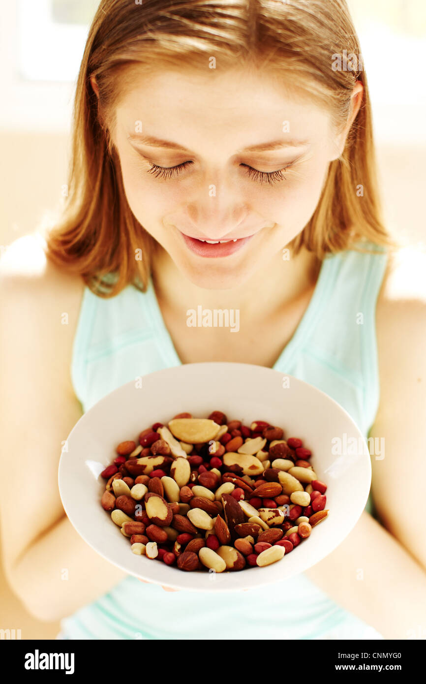 Girl eating nuts Stock Photo - Alamy
