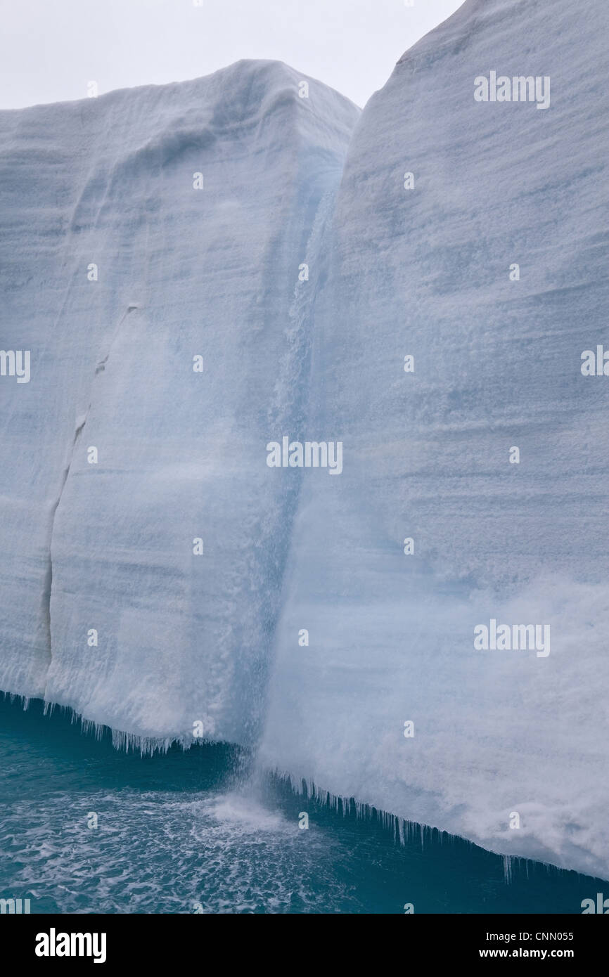 Coastal glacier terminus with waterfall from melting ice, Brasvellbreen ...