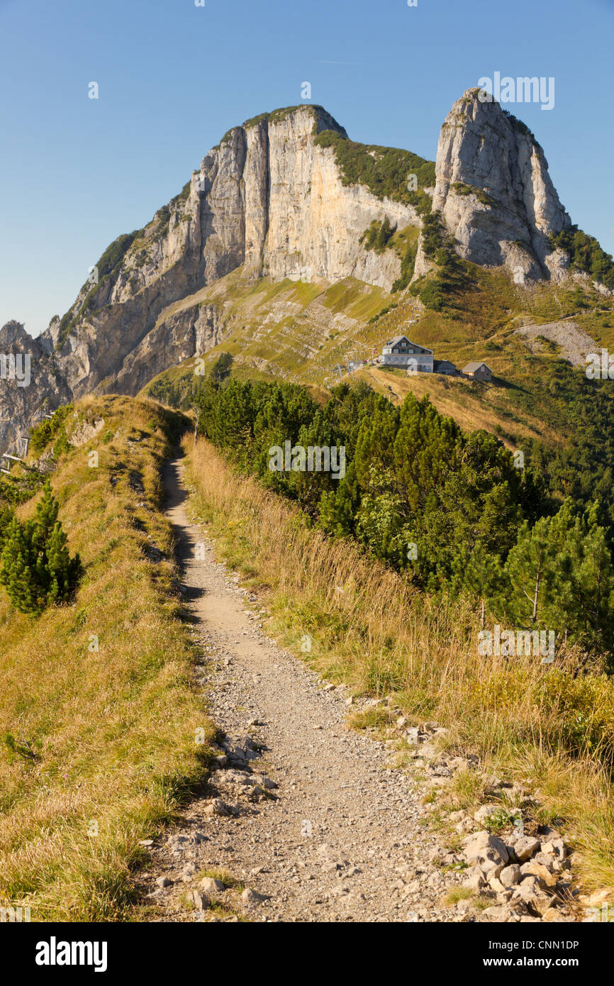 hiking path through rocky mountainous terrain with rest house and ...