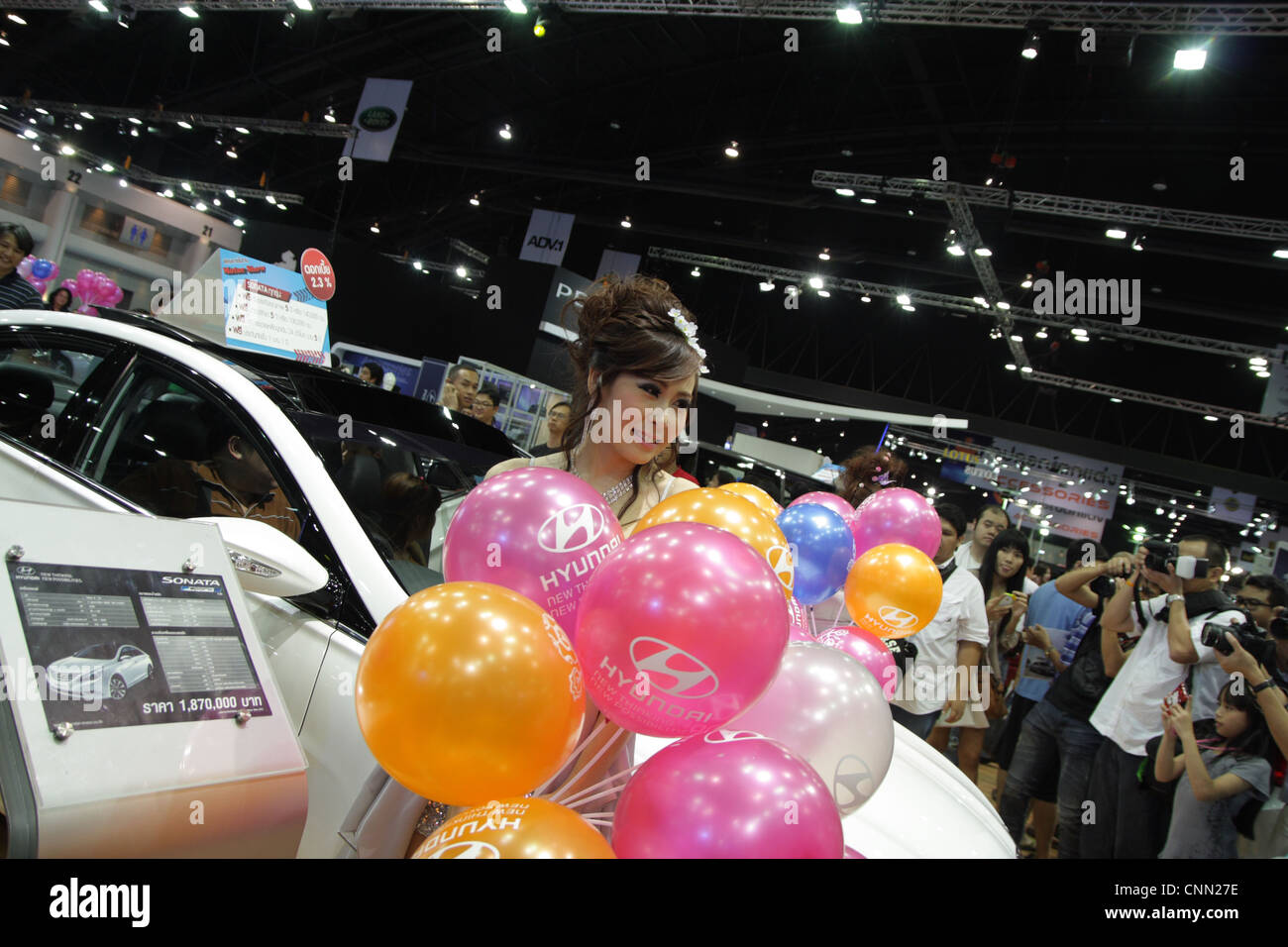 Presenter posing with car in Thailand Motor show 2012 Stock Photo - Alamy