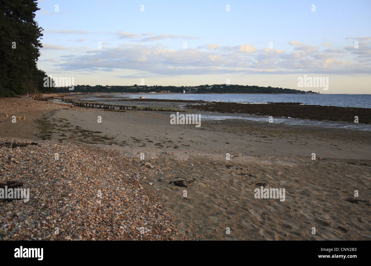 View of beach with incoming tide at dawn, Bembridge, Isle of Wight ...