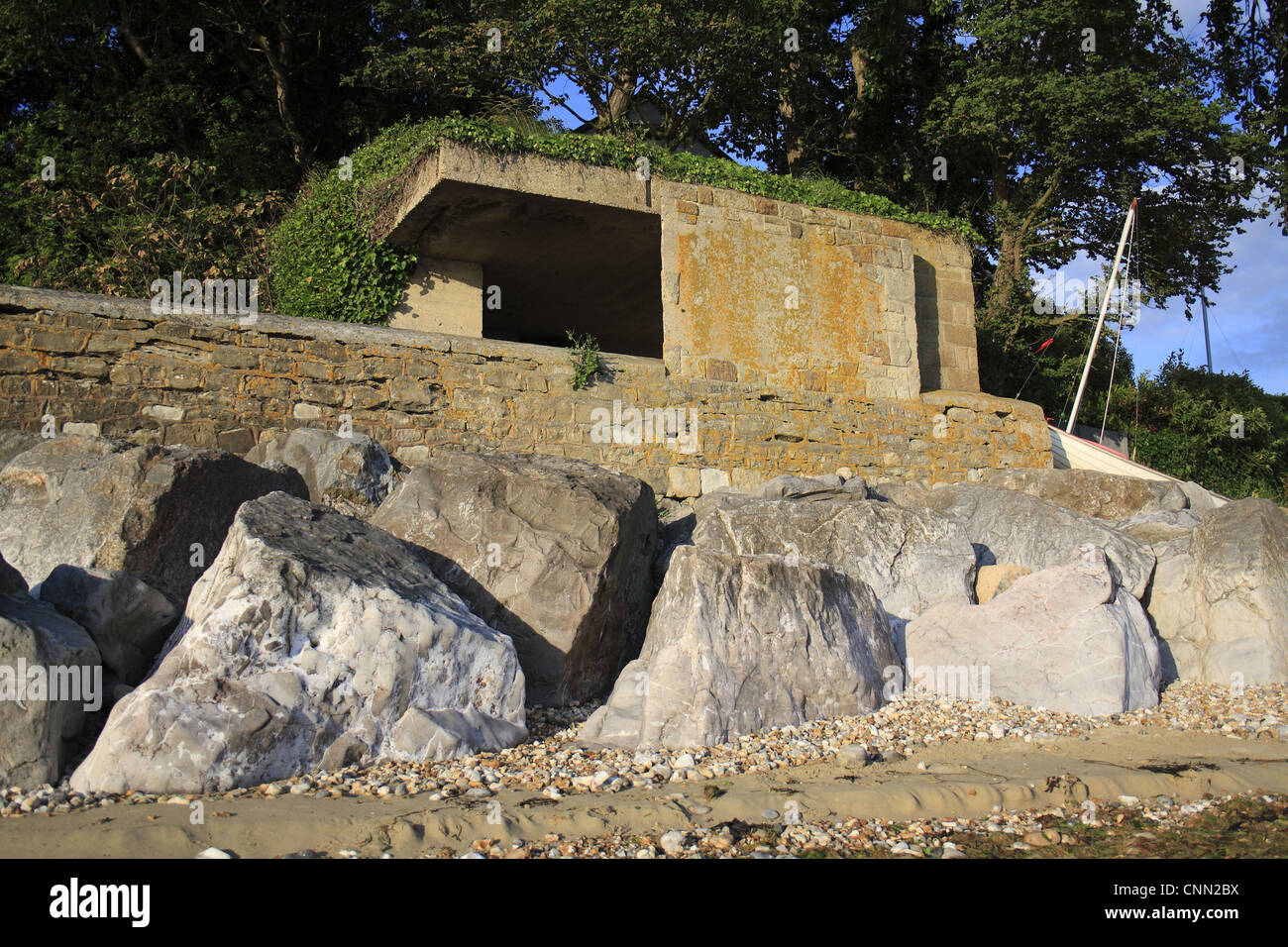 World War Two gun emplacement and riprap boulders at edge of beach ...