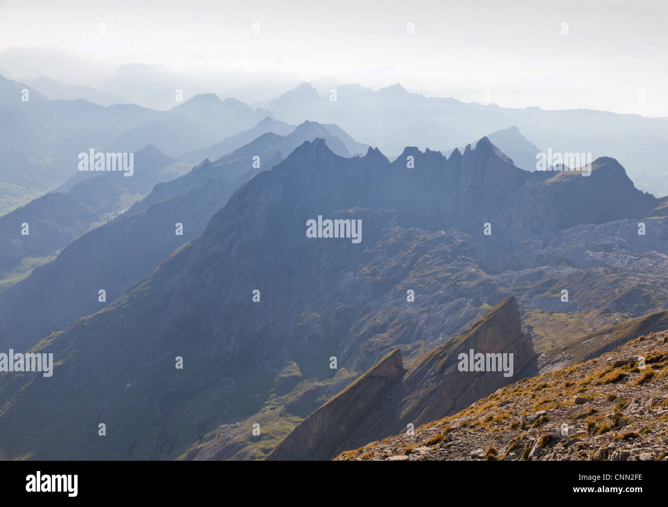 high alpine ragged sharp mountain top ranges disapear in misty distance ...