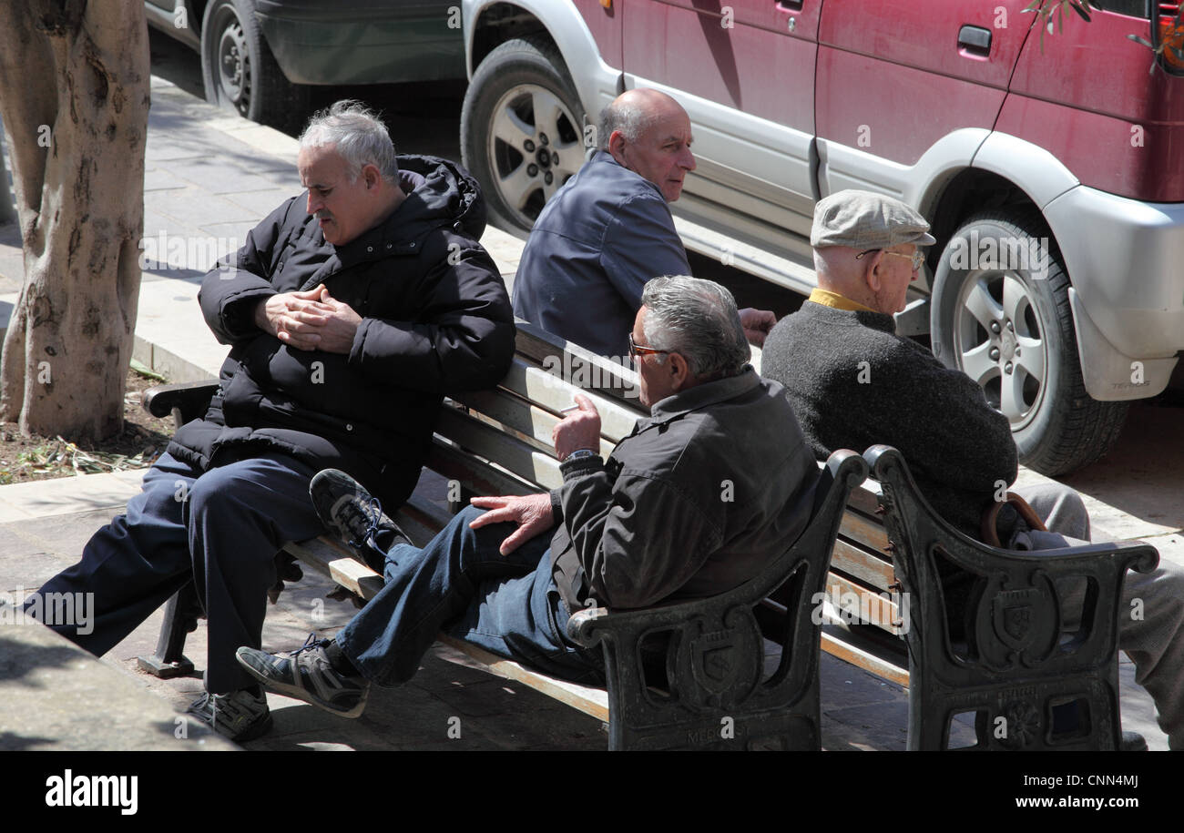 Old men sitting on benches hi-res stock photography and images - Alamy
