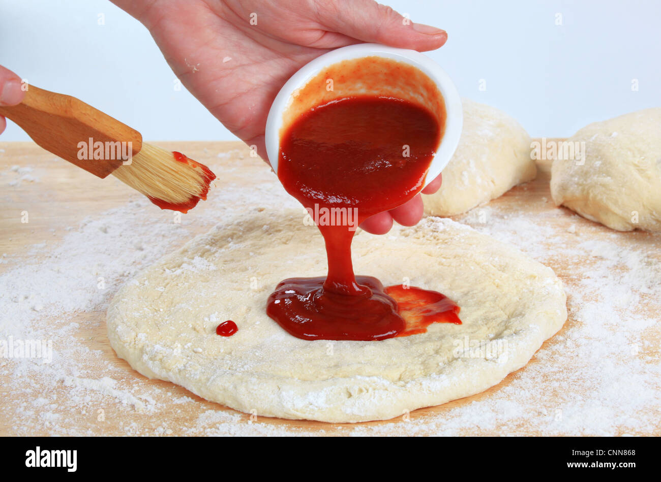 Pouring sauce over pizza hi-res stock photography and images - Alamy