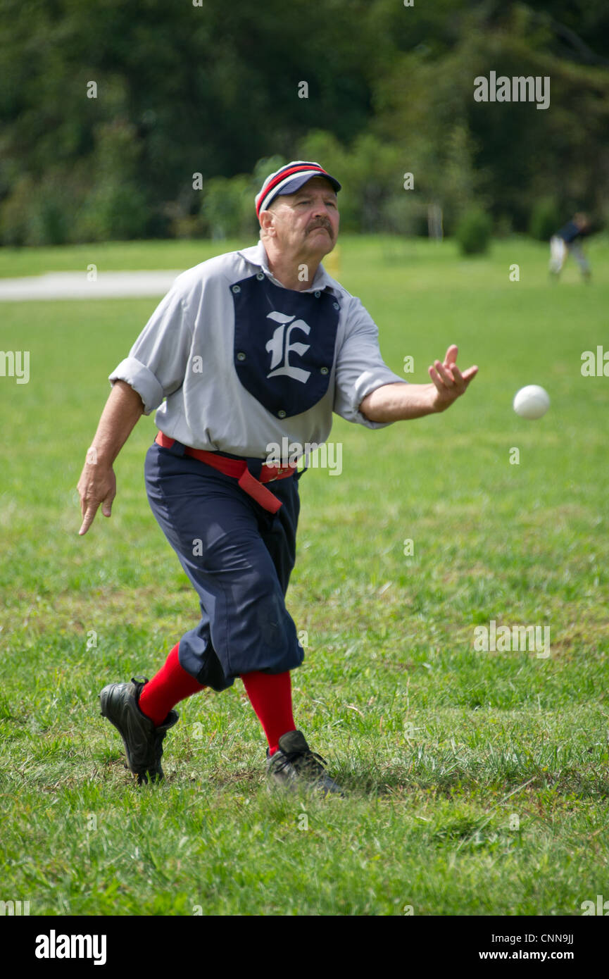 Pitcher pitching the ball in game dressed in vintage uniform playing ...