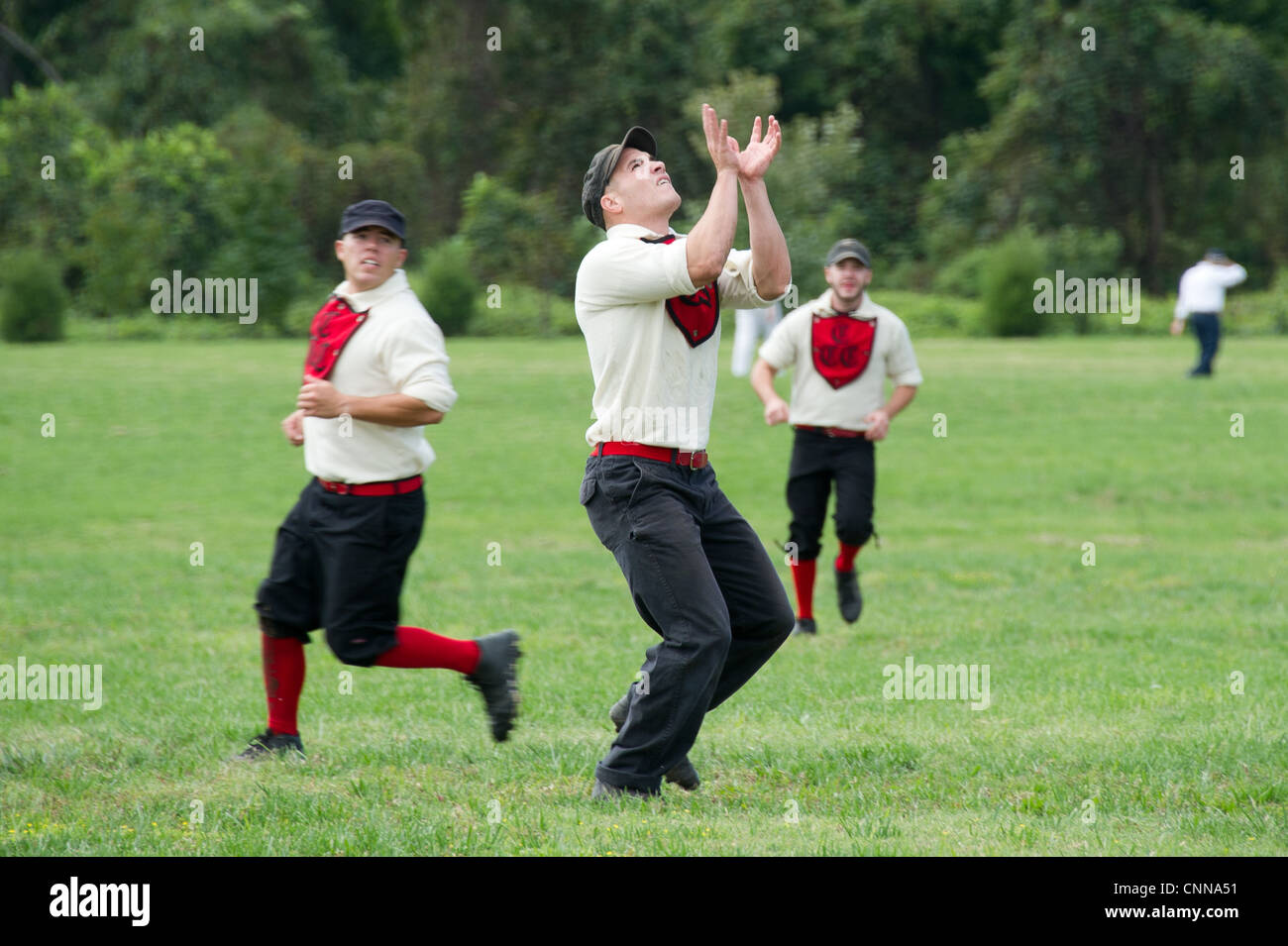 Outfielder catching ball dressed in vintage uniform playing vintage ...