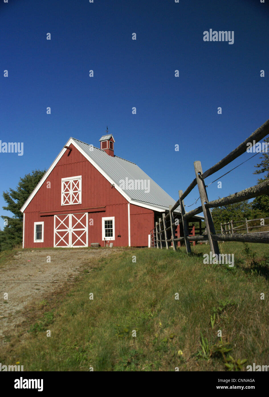 New England red barn and fence against blue sky. Mount Desert Island ...