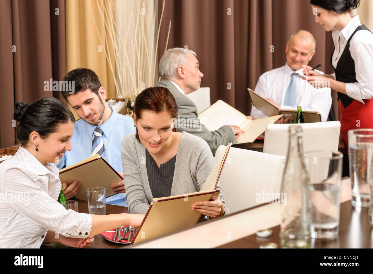Business lunch executive people looking menu ordering meal at ...
