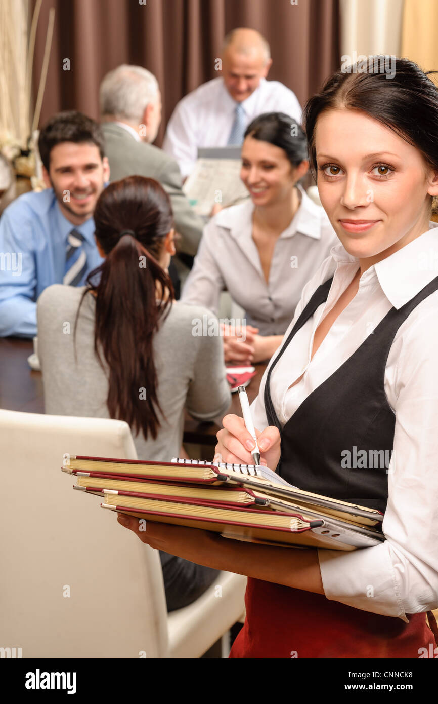 Young waitress hold menu business people have lunch at restaurant Stock ...