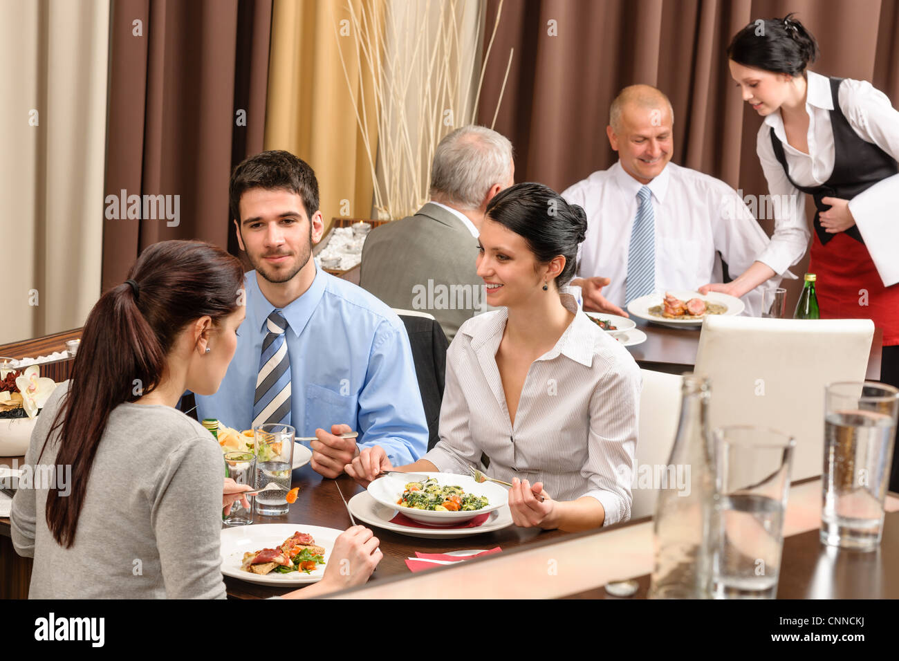Business people enjoy lunch meal at restaurant management discussion ...