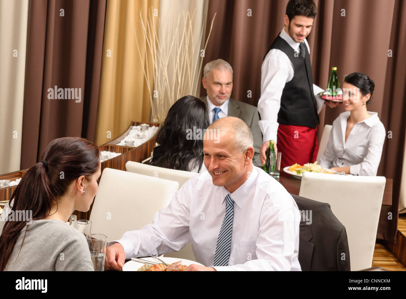 Business people enjoy lunch meal at restaurant management discussion ...