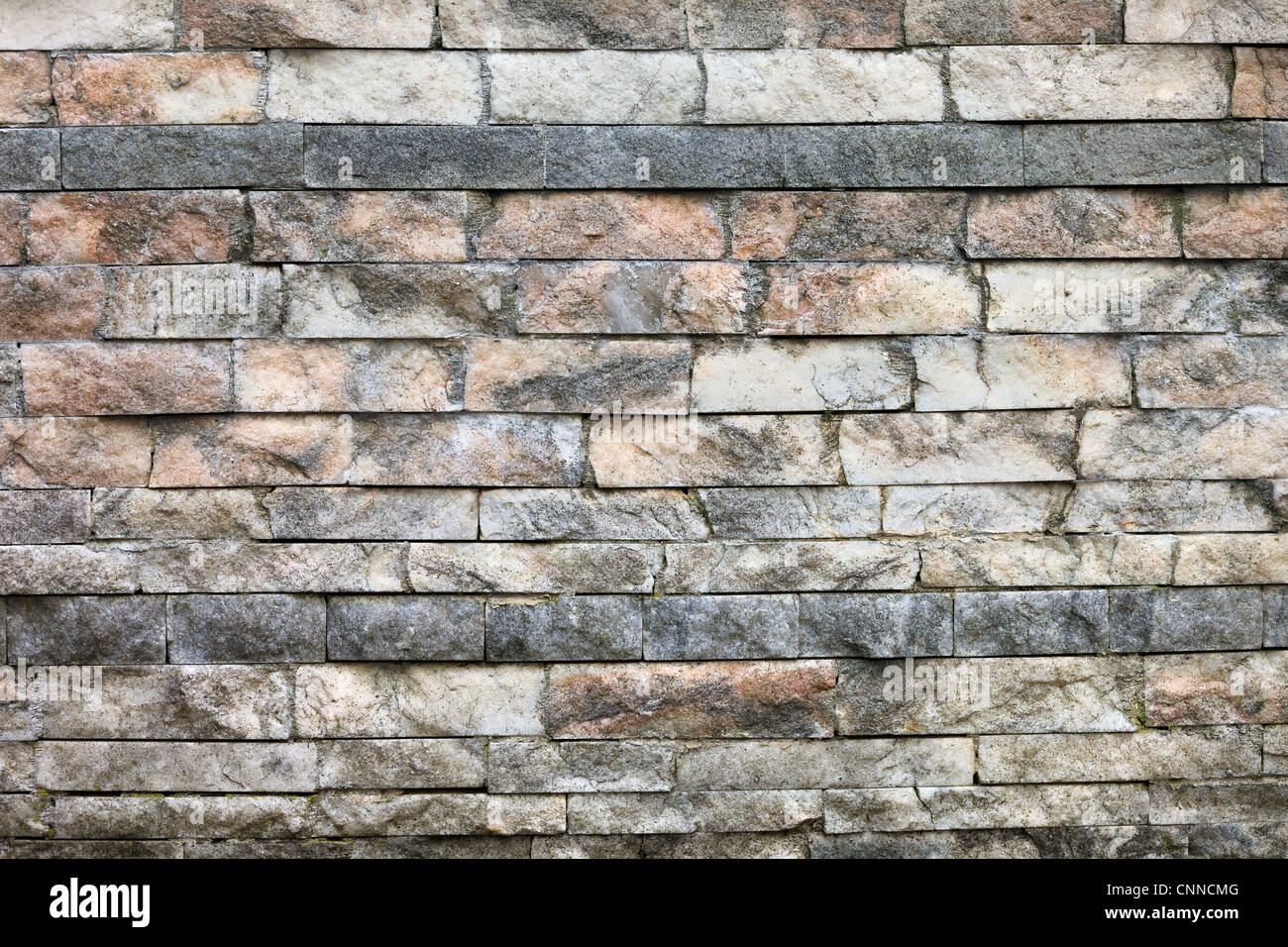 Wall texture made from rough untreated marble bricks of different sizes ...